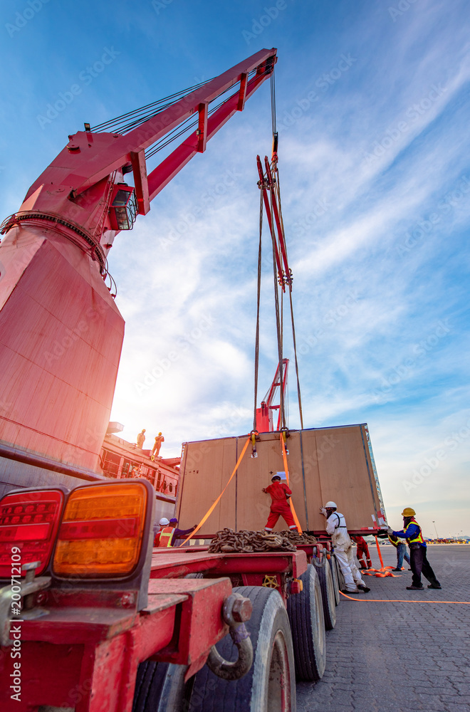 Foto de cargo shipment of heavy package lifting by jumbo crane of the ...