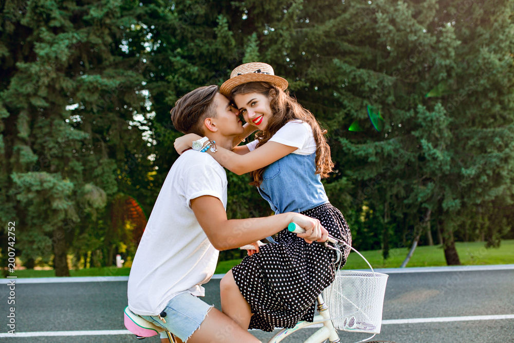 Romantic couple in love on bike on road on forest background. Handsome ...