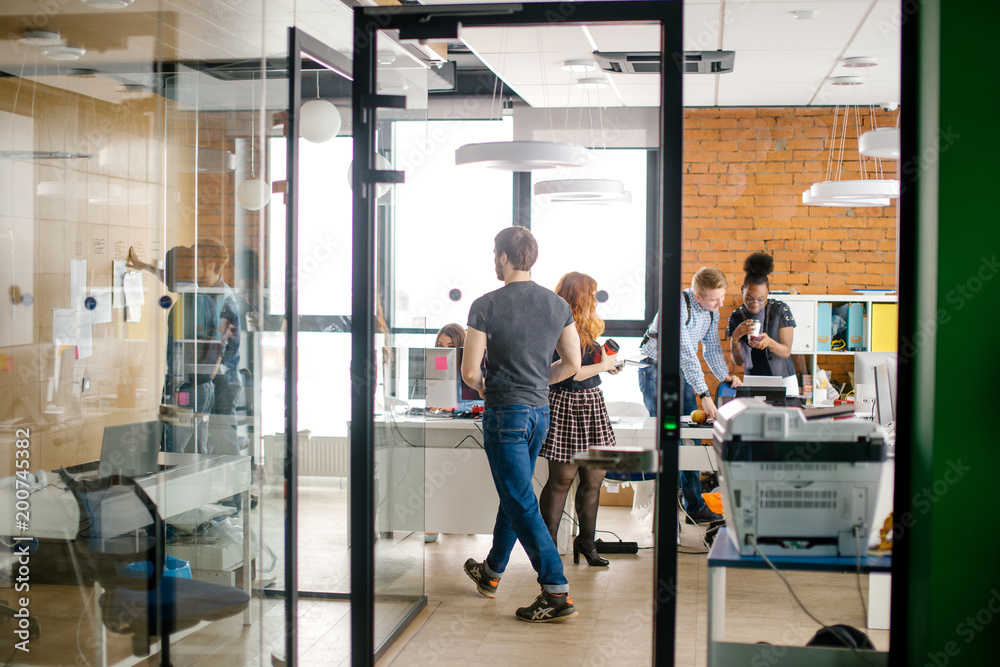 back side view of Caucasian man rushing to her workplace in the loft ...