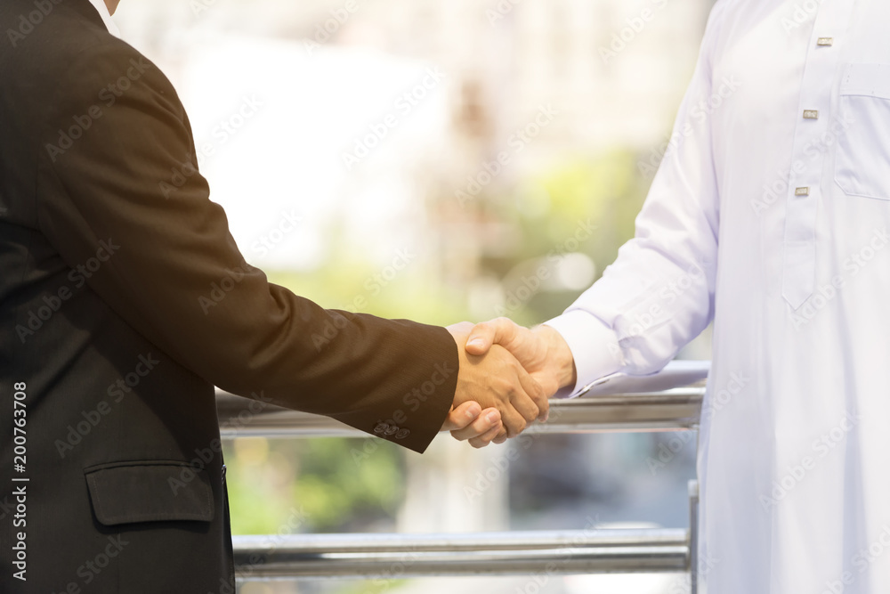 Closed up two businessman making handshake to promise their business ...
