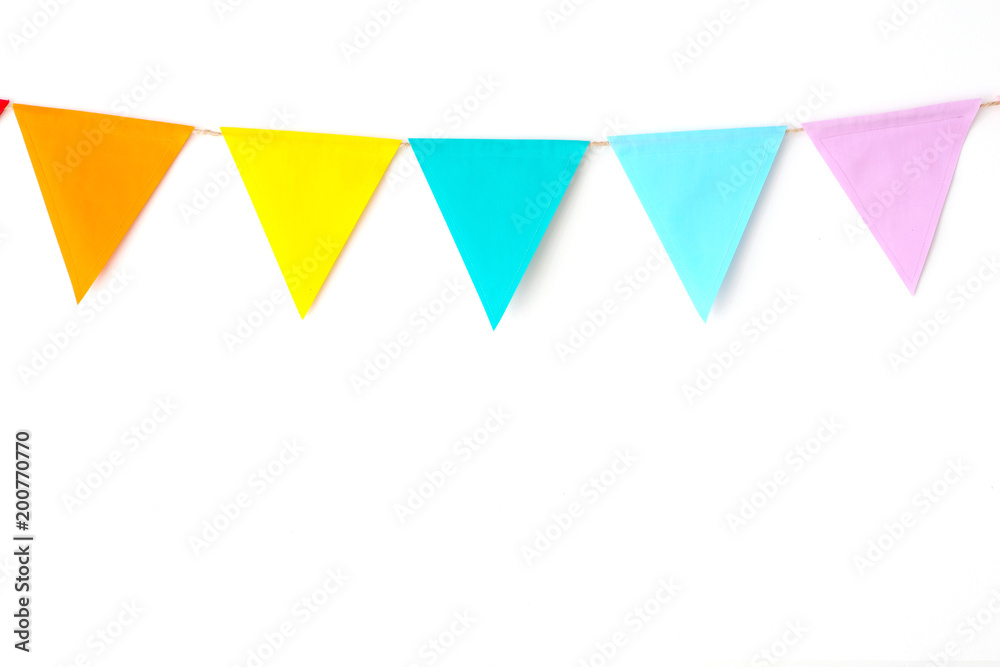 Colorful party flags hanging on white wall background, birthday ...