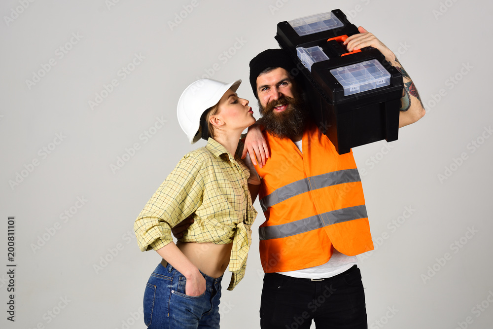 Housewife flirting with repairman with toolbox. Girl with helmet on ...