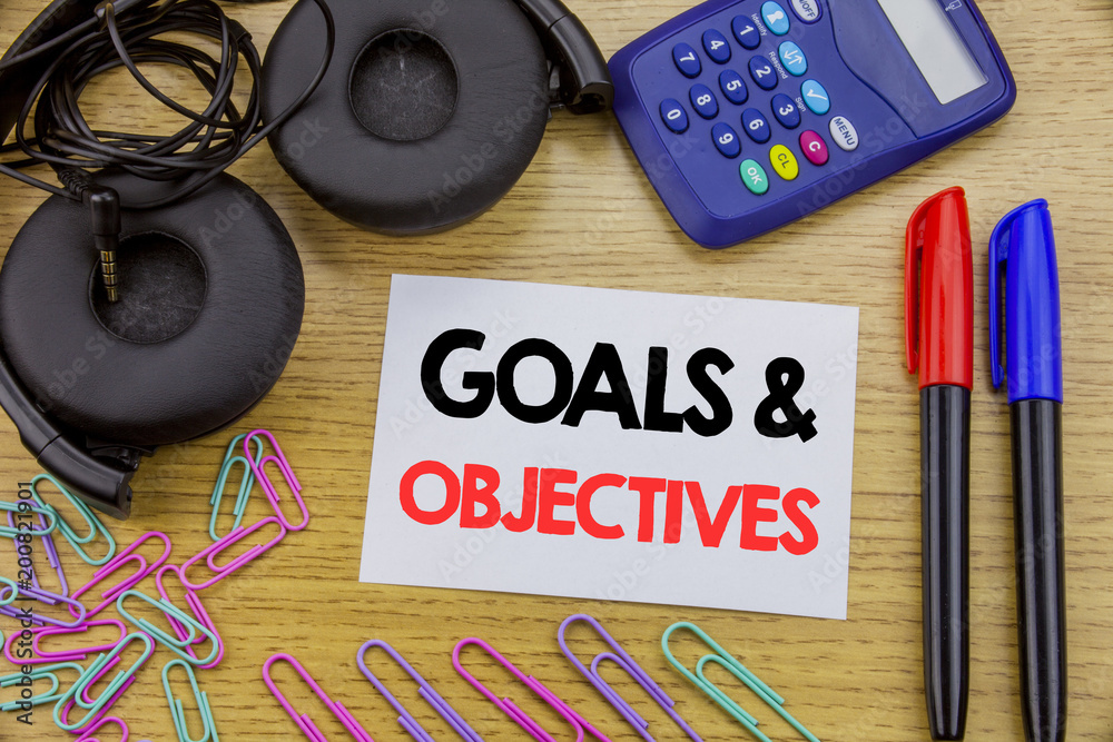 Writing text showing Goals Objectives. Business concept for Plan ...