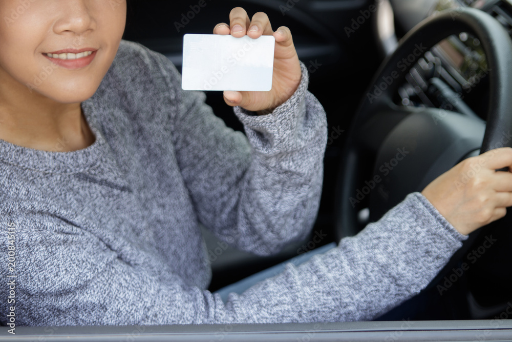 Attractive young asian woman proudly showing her drivers license ...