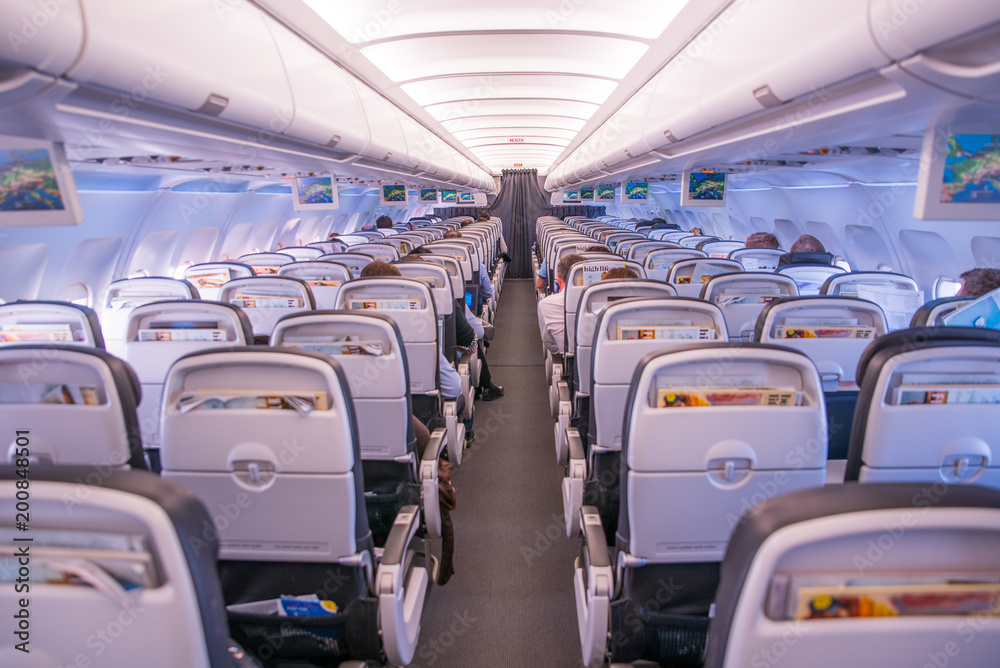 Airplane inside. Seats in row. Stock Photo | Adobe Stock