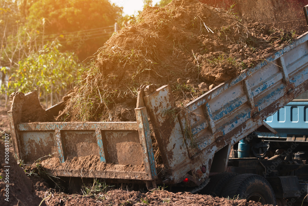 dump truck preparing ground for landscape improvement at property ...