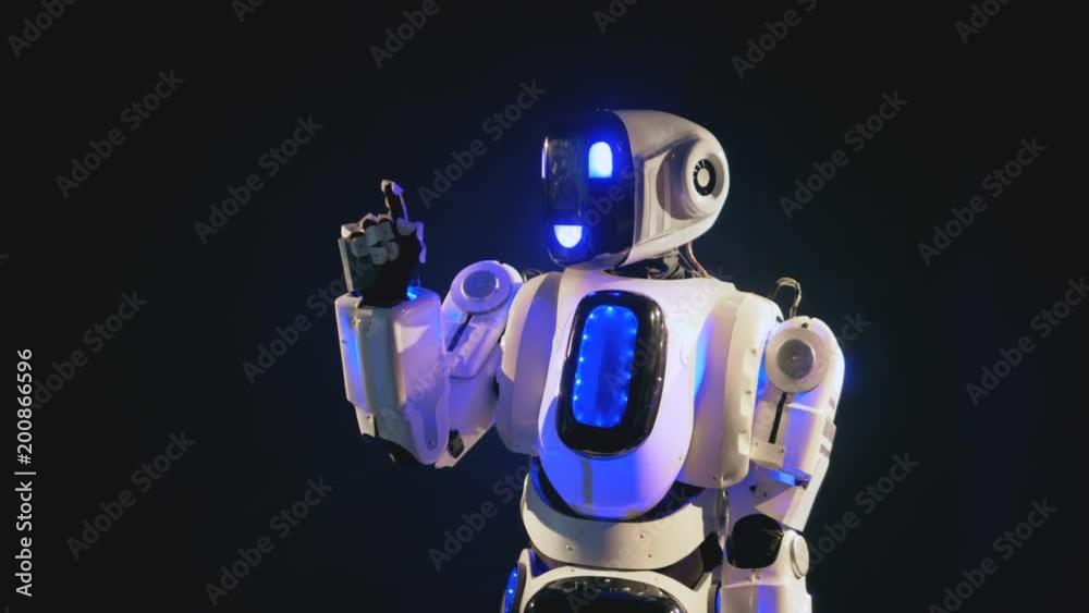 White cyborg stands, while dialling numbers on ivisible board with both ...