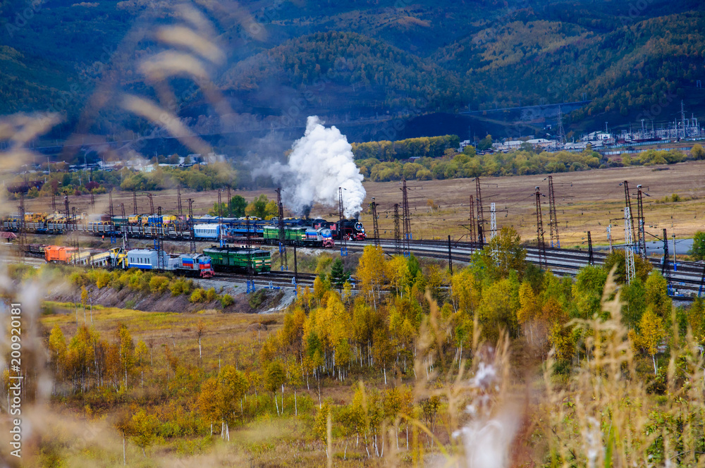 Old steam locomotive in the Circum-Baikal Railway with smoke in autumn ...