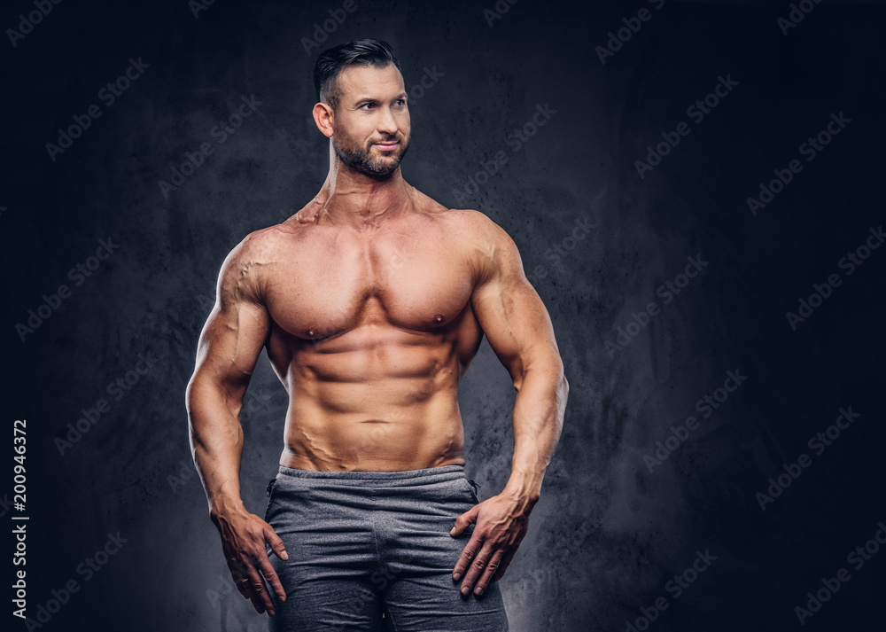 Portrait of a shirtless tall huge male with a muscular body with a ...