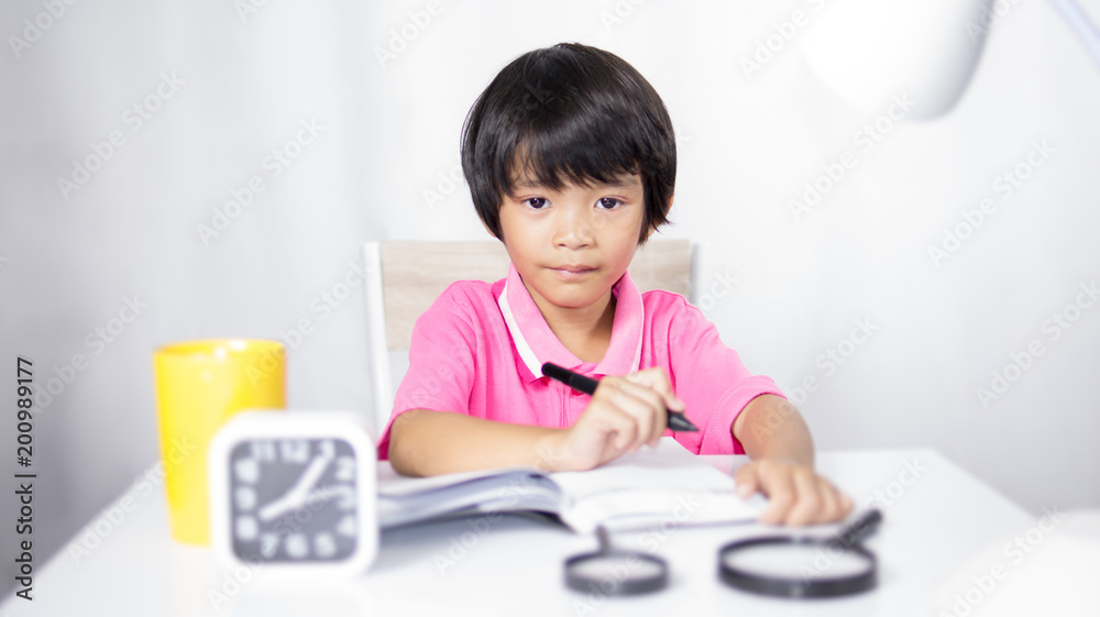 Soft cute child working on work desk. Asian child girl is active and ...