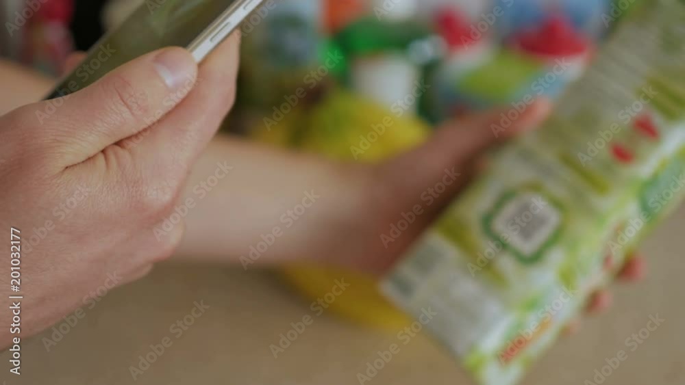 A man scans the QR code on a check on a juice box from a supermarket ...
