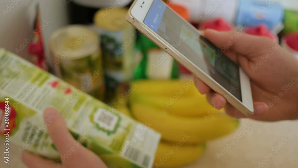 A man scans the QR code on a check on a juice box from a supermarket ...