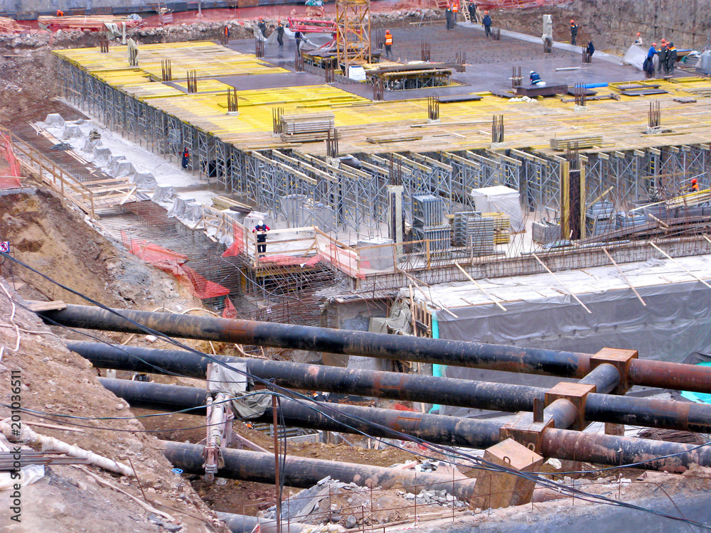 Construction site in the city. Group of builders on the erected ...