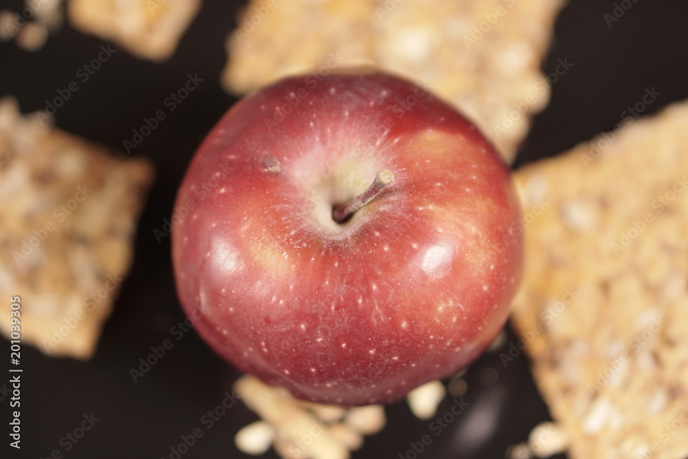 Red apple and crips on black background. Stock Photo | Adobe Stock