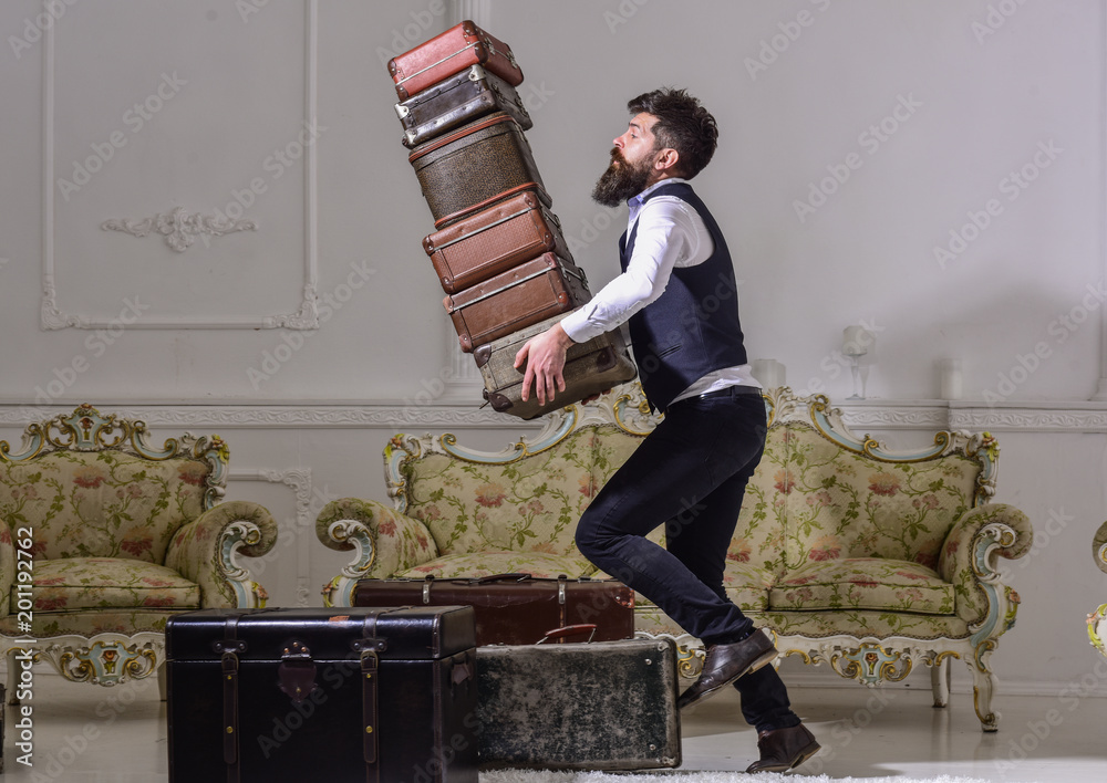 Macho elegant accidentally stumbled, dropping pile of vintage suitcases ...