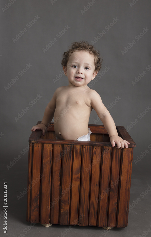 Boy inside box isolated inside studio Stock Photo | Adobe Stock