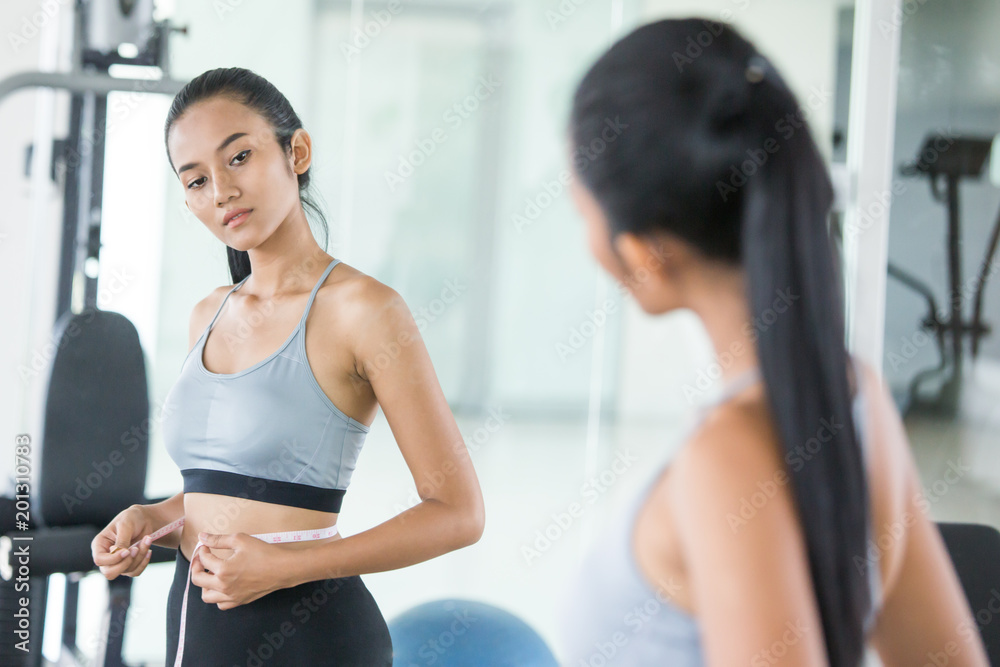 Woman Looking In The Mirror At Body