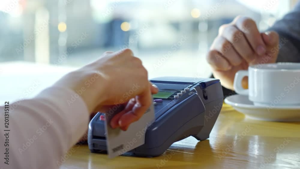 PAN shot with mid-section of hands of unrecognizable man handing credit ...