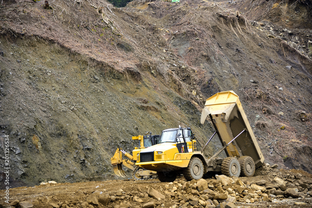 Heavy articulated dump truck work at a huge dam construction site Stock ...