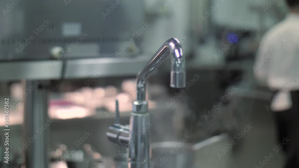 Typical tap in the off state. In the background working process in the ...