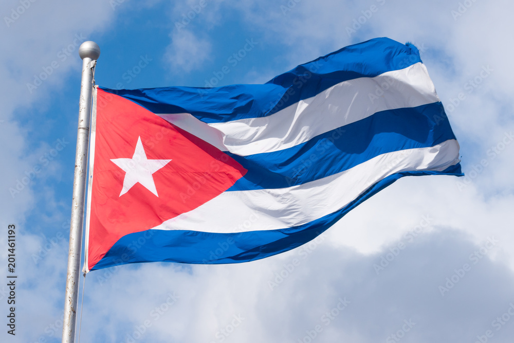 Cuban flag waving in the wind against a blue sky with clouds. Stock ...