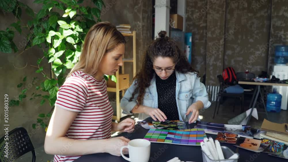 Creative designers are watching professional photos and checking color ...