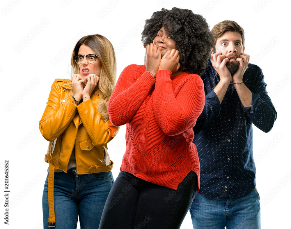Group of three young men and women terrified and nervous expressing ...