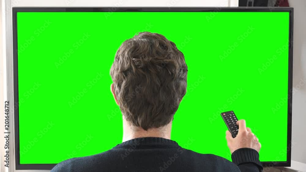 Changing Channels TV Green Screen. Young man changing channels with a ...