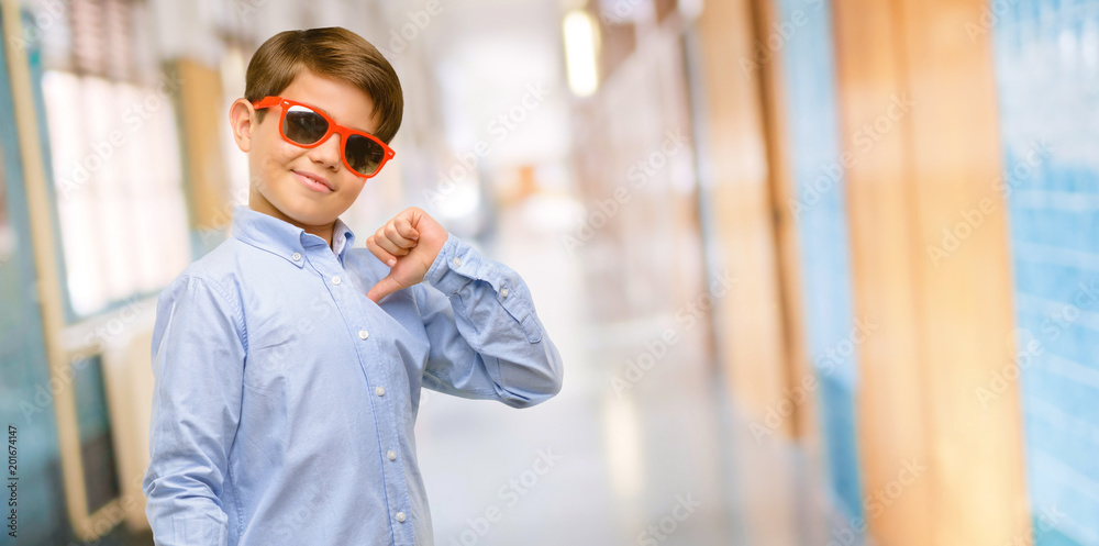 Handsome toddler child with green eyes proud, excited and arrogant ...