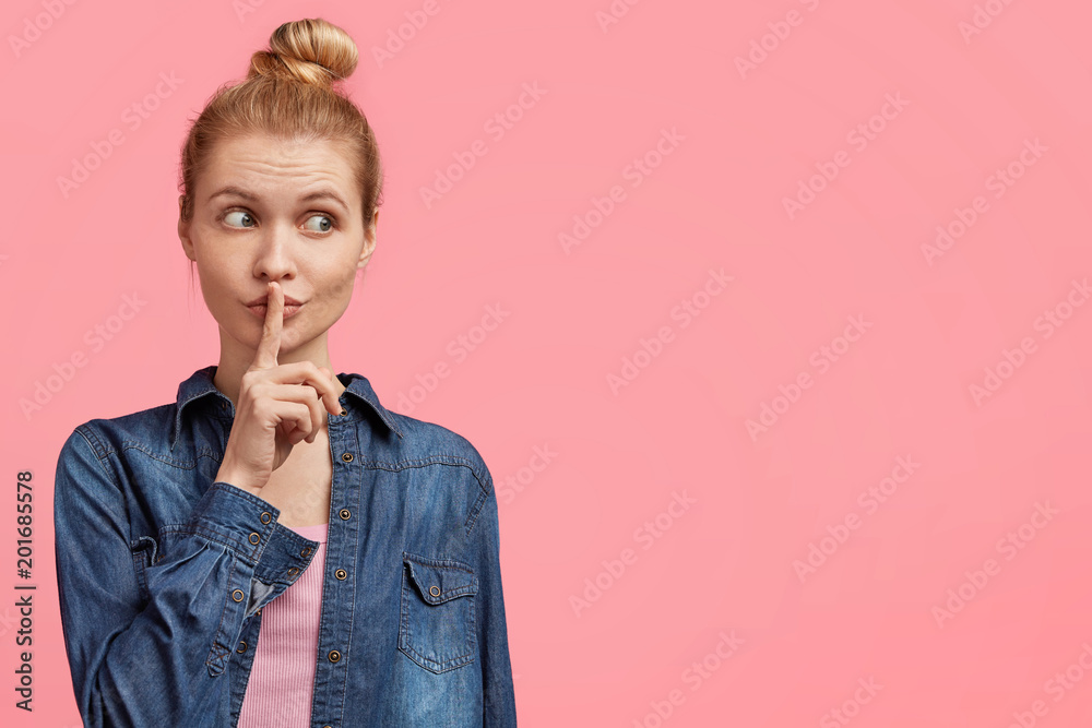 Image of secret female shows silence sign, asks not tell confidential ...