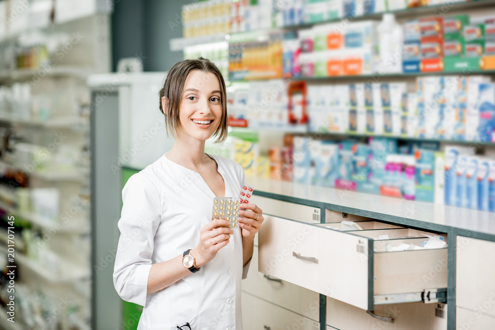 Pharmacist portrait in the pharmacy store Stock Photo | Adobe Stock