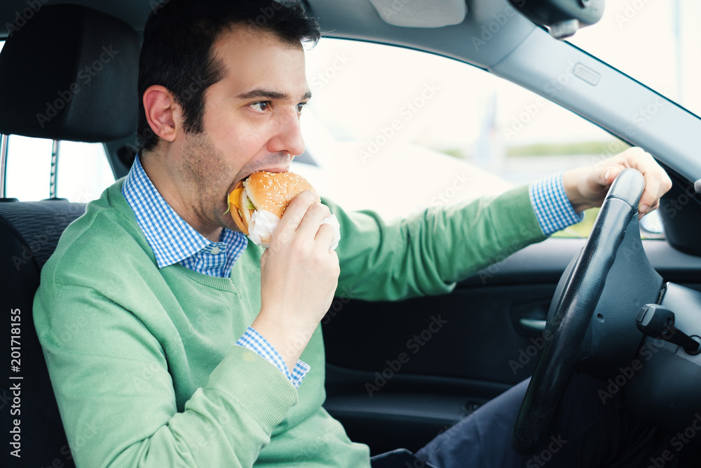 Man Eating Fast Food In A Car