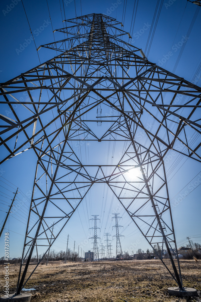 High voltage electrical pylons ruling the sky. Stock Photo | Adobe Stock