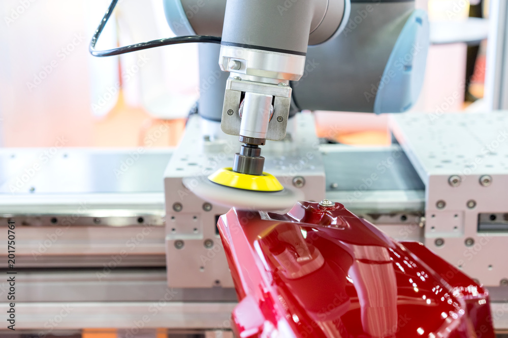 Mechanical hand robot polishing red auto part in workshop Stock Photo ...