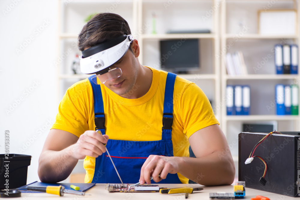 Computer repair technician repairing hardware Stock Photo | Adobe Stock