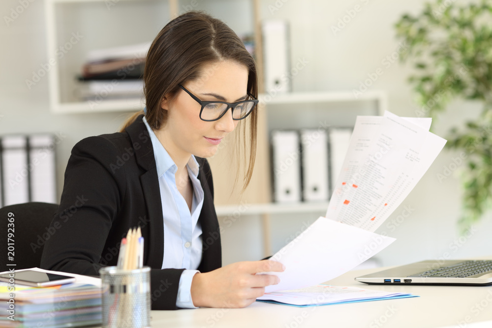 Office worker checking paper documents Stock Photo | Adobe Stock