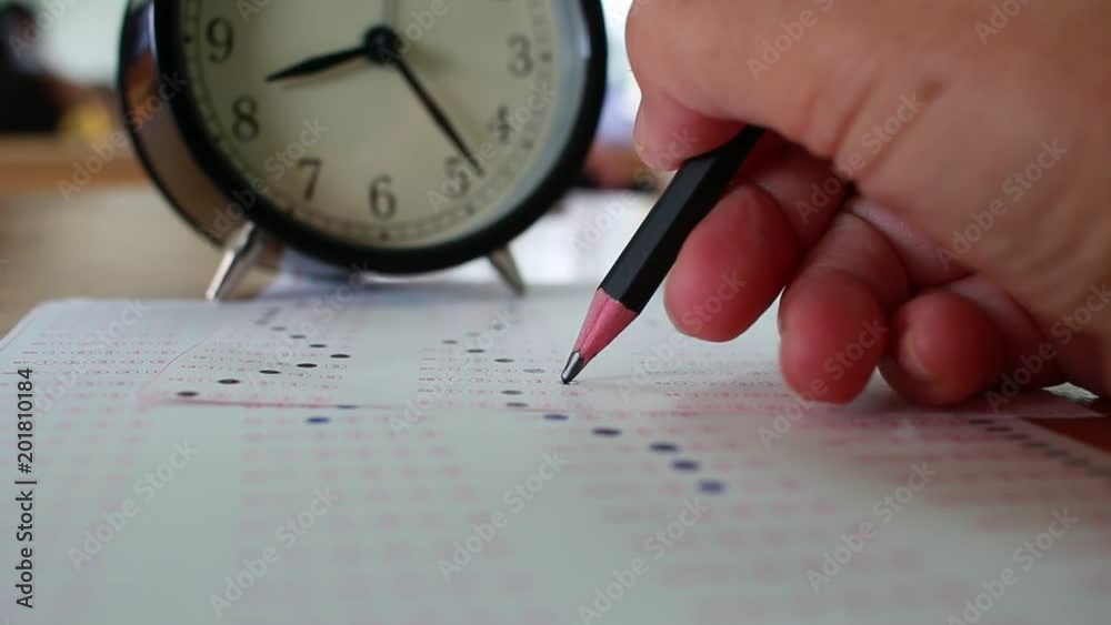 Asian Students taking optical form of standardized exams near Alarm ...