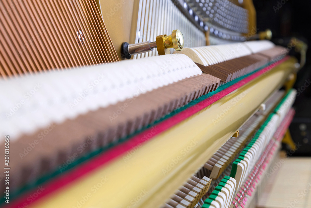 Closeup of the internal parts of an upright piano - mechanics, strings ...