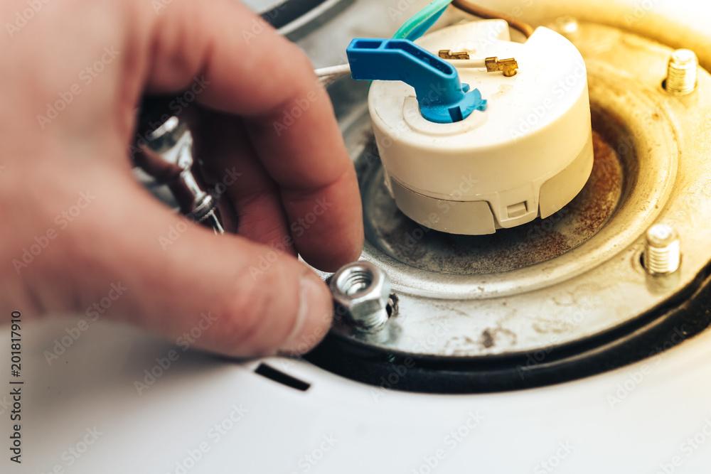 repair of boilers, the hand of the master throws and twists the nuts ...