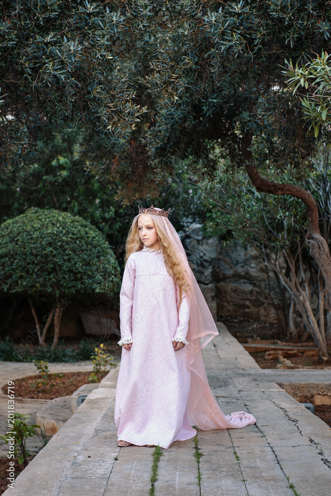 fairy-tale kind white sorceress in a magical forest walks along the ...