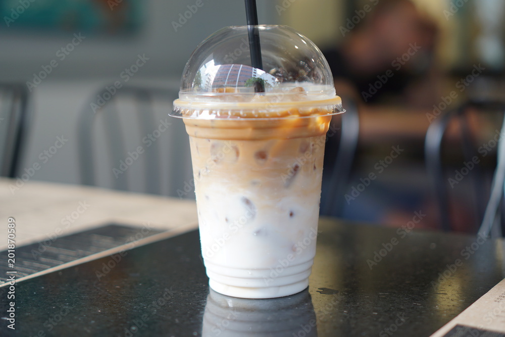 Iced Thai milk tea with milk foam in plastic glass. wall mural ...