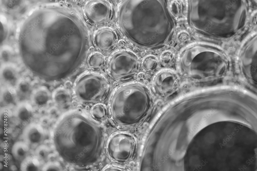Black-and-white background with big and small grey bubbles inside a ...