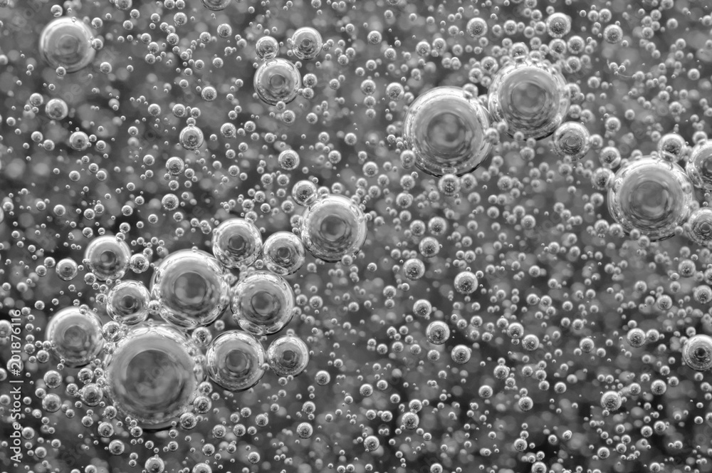 Black-and-white background with big and small grey bubbles inside a ...