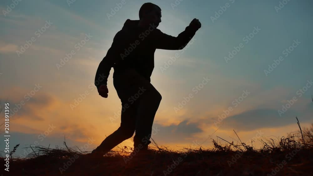man boxer boxing on nature silhouette sunset sunlight. kickboxer the ...