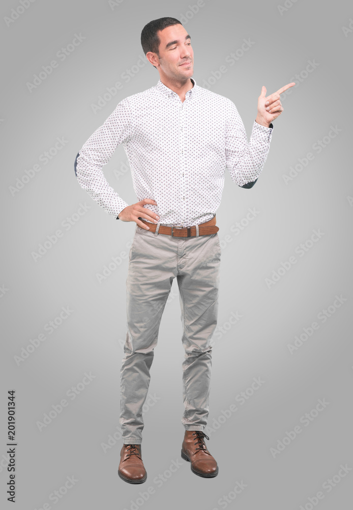 Confident young man pointing with his hand - Full body shot Stock Photo ...