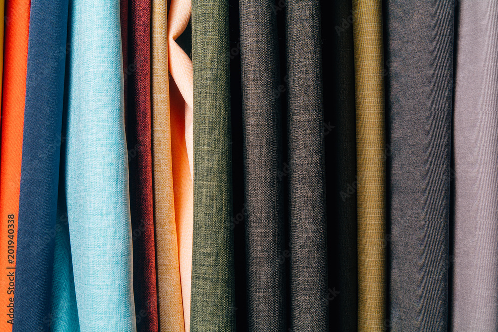 Different types of fabrics are stacked in a row Stock Photo | Adobe Stock