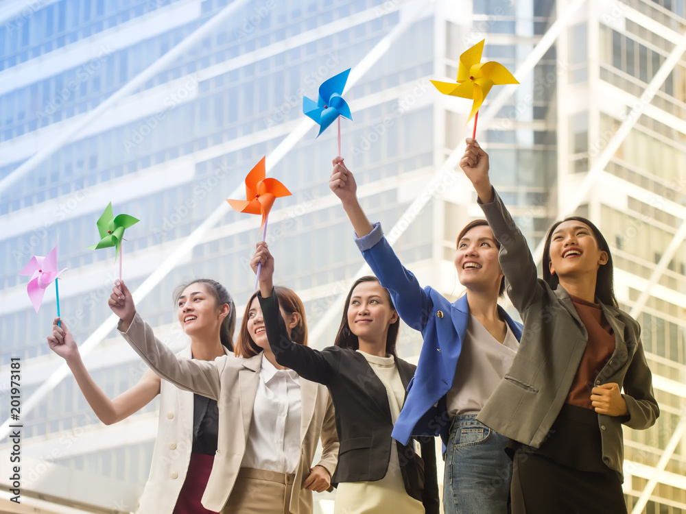 Beautiful business woman team are shown paper turbine. Business ...