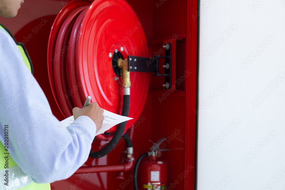Engineer inspection Fire extinguisher and fire hose. Stock Photo ...