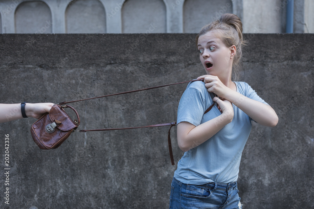 Someone is snatching and dragging a purse from woman's hands, picture ...