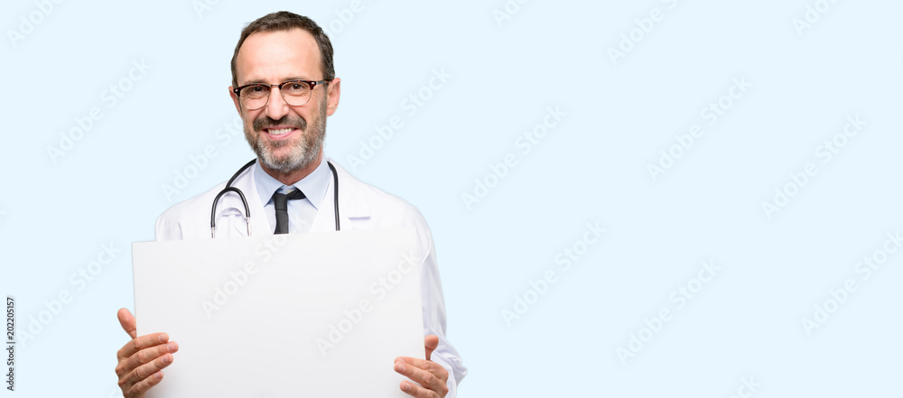 Doctor senior man, medical professional holding blank advertising ...